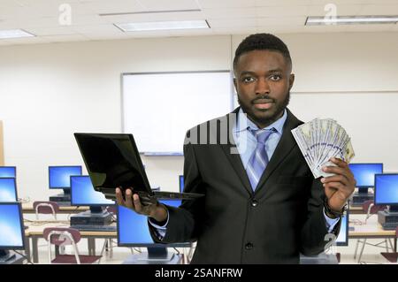 Handsome man with cash using a computer Stock Photo - Alamy