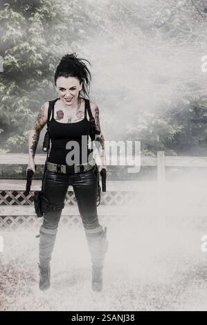 Beautiful young woman shooting things with pistols Stock Photo - Alamy