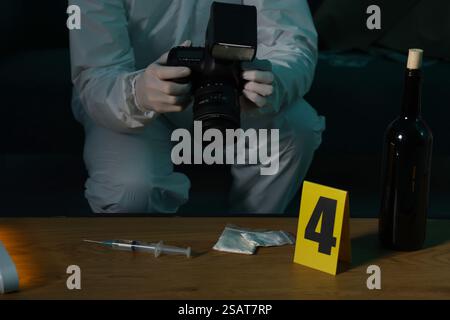 Forensic expert with camera working at crime scene indoors Stock Photo ...
