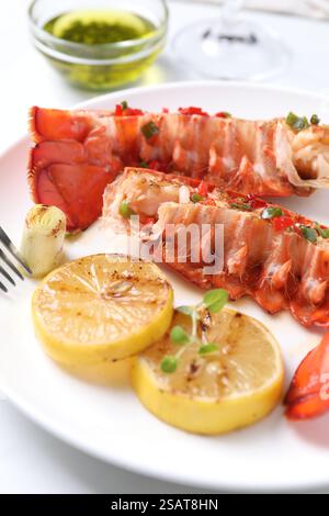 Delicious lobster tails with lemon, microgreens and green onion on ...