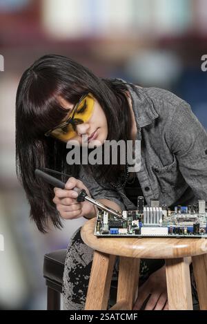 Beautiful woman repair soldering a printed circuit board Stock Photo ...