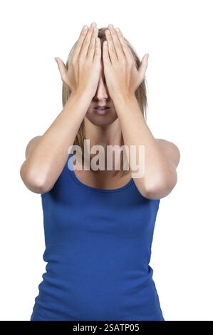 Scared young woman covering eyes on red background Stock Photo - Alamy