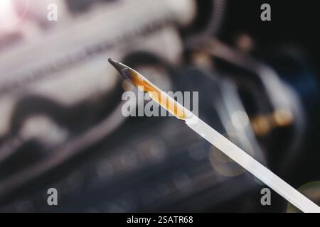Metal dipstick showing oil level used for engine maintenance in ...