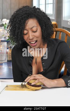 Beautiful woman using the mouse trap diet plan Stock Photo - Alamy