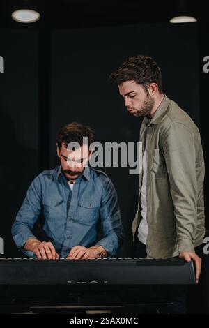 Two musicians on stage under the spotlight during the concert Stock ...