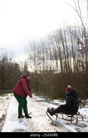 A woman pulls a child through the snow after a winter storm in Toronto ...