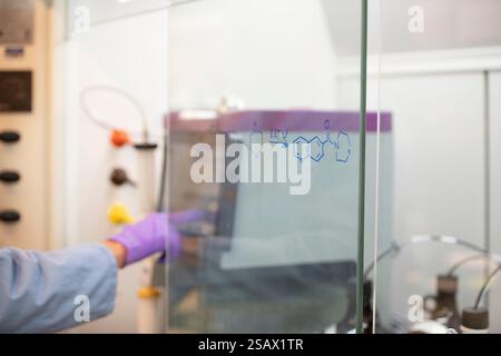 Formula written on glass of biotech hood in science medical lab Stock ...