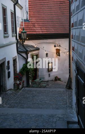 Cozy Alley with String Lights and Outdoor Seating Stock Photo - Alamy