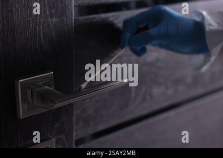 Forensic expert taking blood sample from handle of door, closeup Stock ...