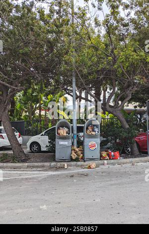 Overfilled fast-food Burger King trash bins with litter in public ...