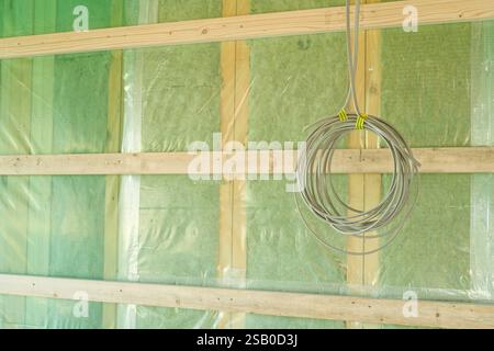 The first fix by electricians in wiring a property. Coiled wire ready for installation. Vapour ...