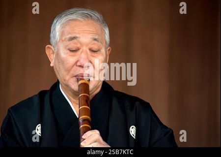 Man playing a shakuhachi: Japanese longitudinal, end-blown flute made ...