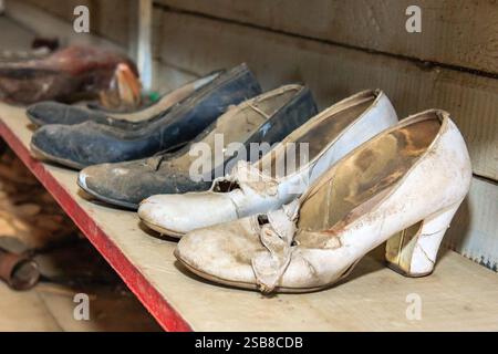Used black shoes on shelf Stock Photo - Alamy