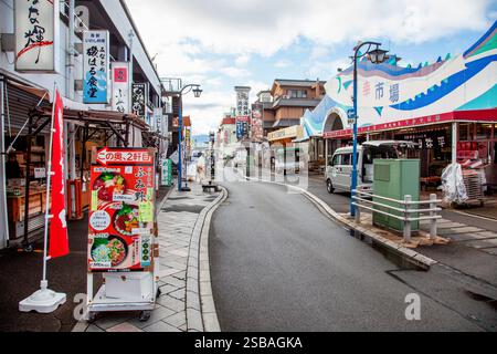 A winding street in Numazu Port lined with seafood restaurants and ...
