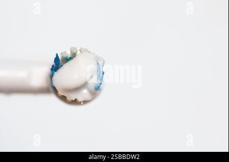 toothpaste and toothbrush top view with copy space on colored ...