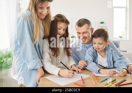 happy children draw together at the table Stock Photo - Alamy