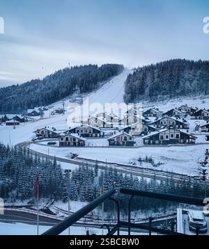 Cottages in the mountains covered in snowy valley Stock Photo - Alamy