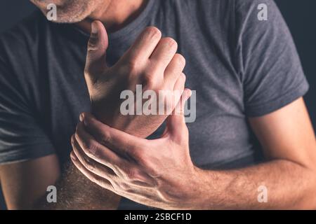 Severe wrist pain symptoms, man with painful medical condition ...
