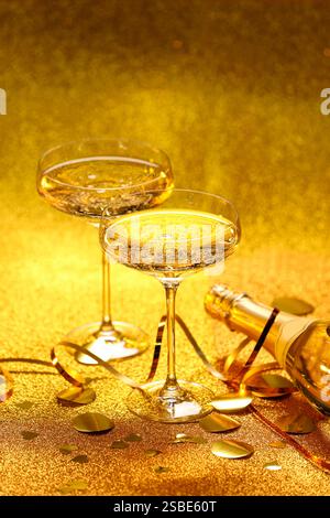 Champagne, confetti and streamers on golden background Stock Photo - Alamy