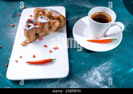 Homemade raspberry and banana pie and cup of tea on wooden table ...
