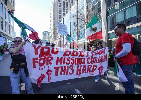 Carrying an anti-ICE banner a demonstrator stands in the middle of the ...