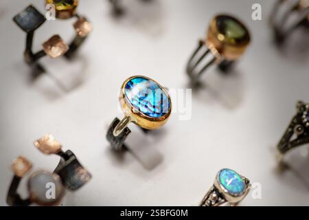 A close-up of multiple gemstone rings with unique designs, elegant ...