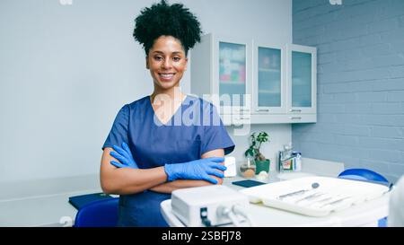 Confident female dentist in dental office with male patient in chair ...