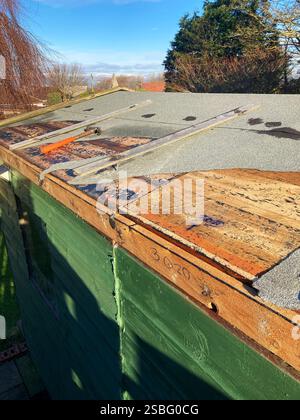 Old Garden Shed with a wind storm damaged roof with ripped felt and ...