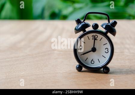 Table alarm clock pointing at 9 am. Time concept and copy space Stock ...