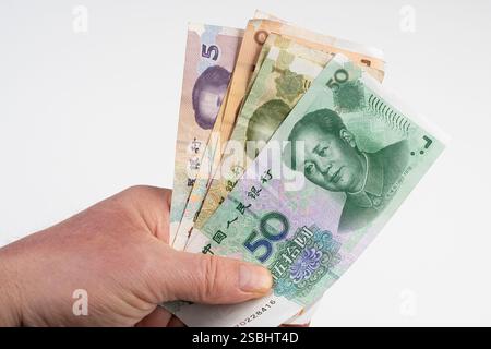 Some chinese Renminbi banknotes in the hand Stock Photo - Alamy