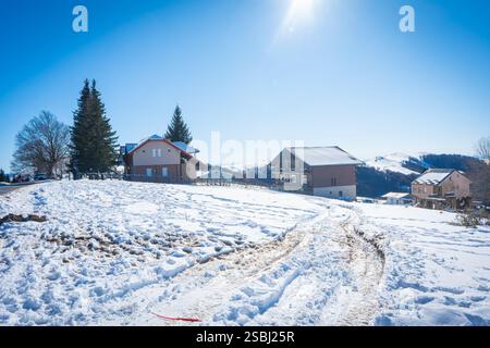 Panoramic view down snow covered valley in alpine mountain range on ...