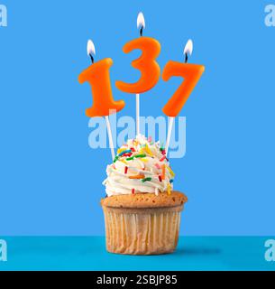 Candle number 137 - Cupcake birthday in blue background Stock Photo - Alamy