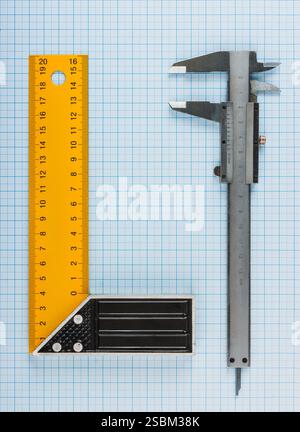 calipers, bearing and square on the background of graph paper Stock ...