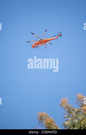 A firefighting helicopter returns from the fire zone, after aiding ...