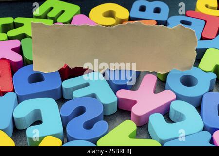 Torn paper placed on Colorful Letters of Alphabet Stock Photo - Alamy