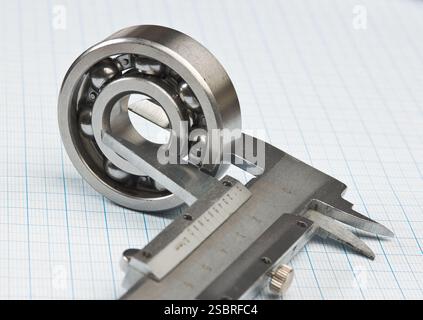 calipers, bearing and square on the background of graph paper Stock ...