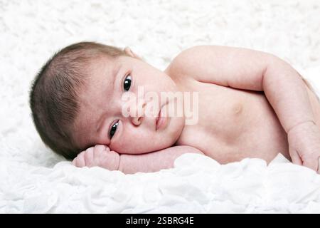 Adorable hispanic baby lying on bed crying at bedroom Stock Photo - Alamy