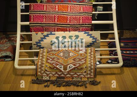 Traditional Turkish rug textile with patterns in bazaar Stock Photo - Alamy
