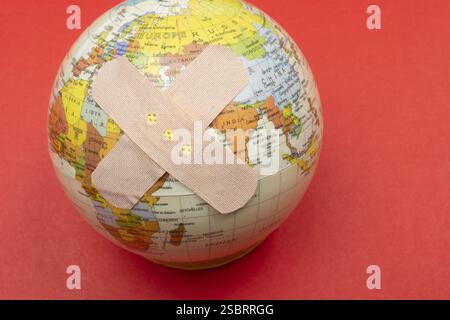 Earth with bandaid Solidarity and aid to countries in need concept ...