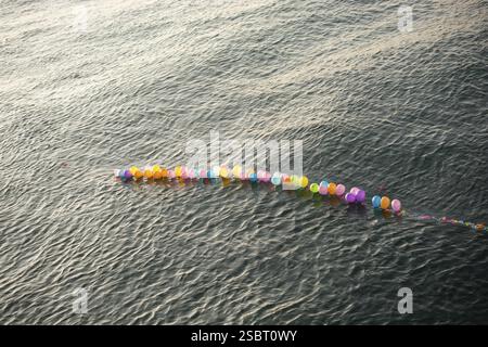 Balloon on a string on water for shooting game Stock Photo - Alamy