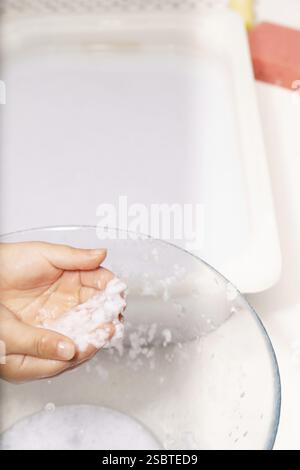 Close-up of kid's hands makes holiday decorations, attaches colorful ...