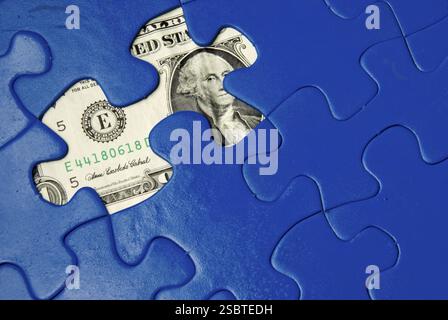 A puzzle covering up a one dollar bill Stock Photo - Alamy