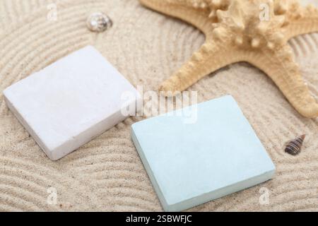 Decorative plaster podiums, starfish and seashells in sand Stock Photo ...