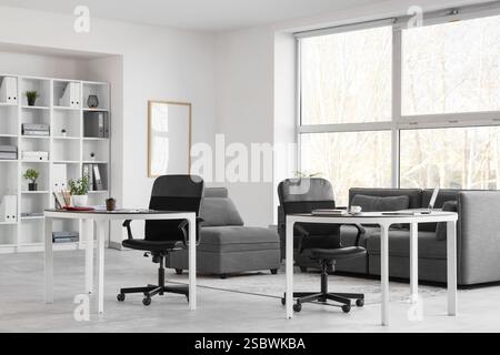 Interior of office with desks, shelf unit and shredder Stock Photo - Alamy