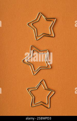 Star shaped paper clips on green background, flat lay. Space for text ...