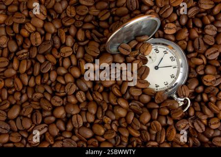 Pocket watch in coffee beans Stock Photo - Alamy