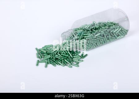 Transparent Plastic Bottle with Green Spherical Pills on White ...