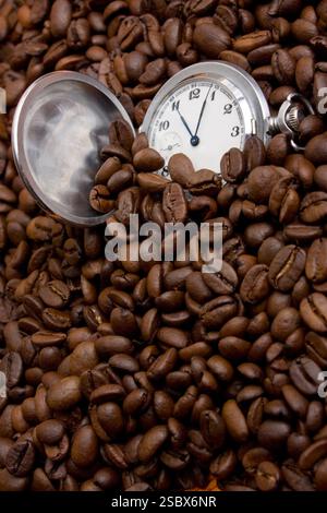 Pocket watch in coffee beans Stock Photo - Alamy
