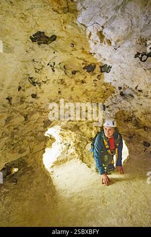Visitor crawling through the Neolithic flint mines of Spiennes, Mons ...