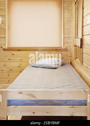 Single bed in the log house bedroom Stock Photo - Alamy